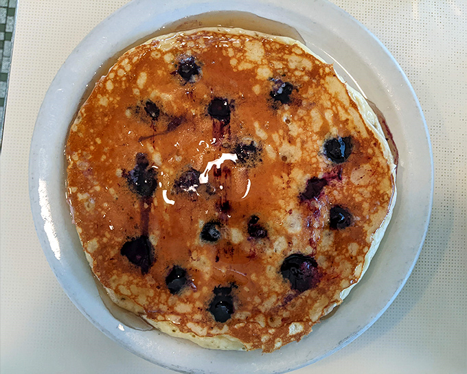 Blueberry pancakes that deserve their own ZIP code. Each berry creates a perfect pocket of sweetness in a golden landscape of breakfast perfection.