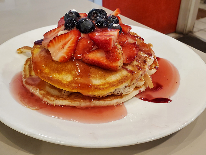 Berry bliss on a plate &ndash; these pancakes aren't just breakfast, they're a sweet celebration topped with fresh strawberries and blueberries.