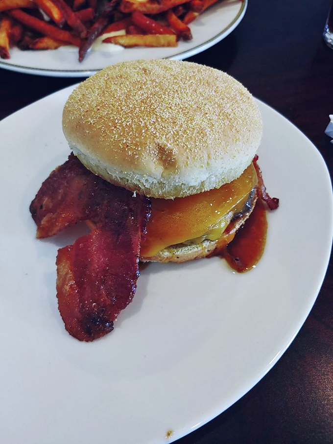 The Bourbon Bacon Burger doesn't just satisfy hunger – it creates memories with its sweet-smoky candied bacon and melty cheese embrace.