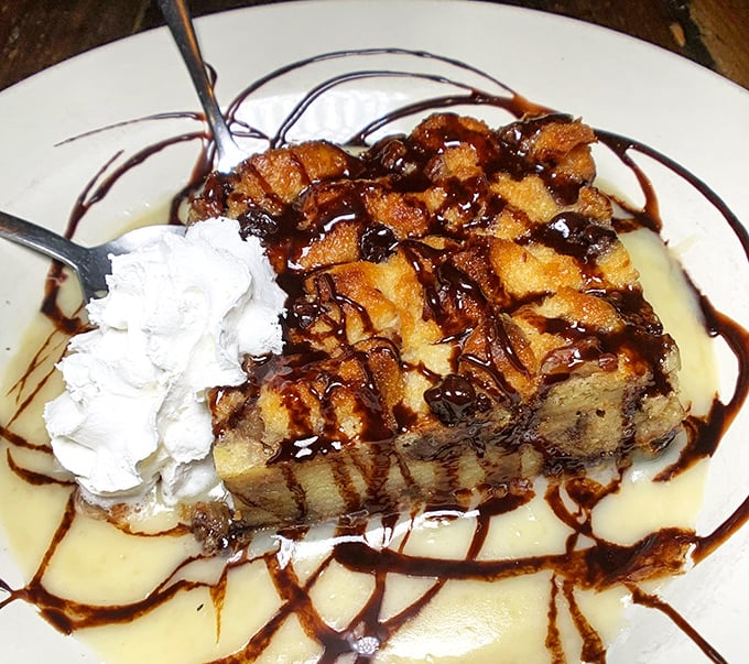 Bread pudding that doesn't just satisfy your sweet tooth but throws it a full-on celebration, complete with whipped cream and decadent drizzles.