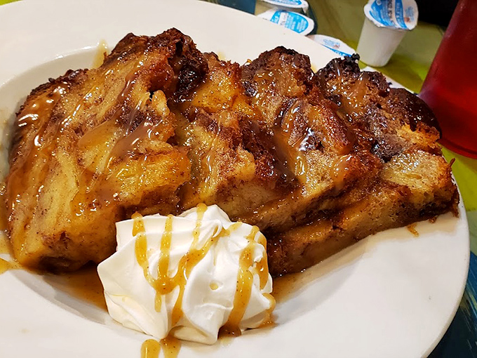This bread pudding isn't just dessert, it's architecture &ndash; layers of caramelized goodness topped with a cloud of whipped cream and caramel drizzle.