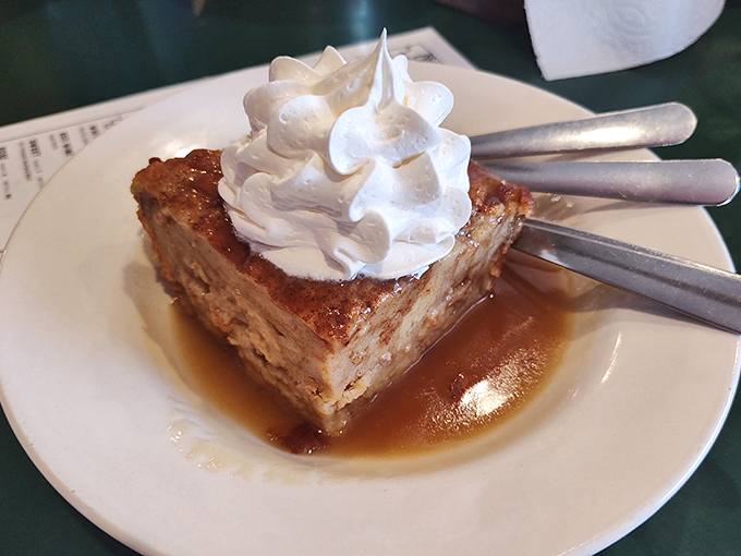 Bread pudding swimming in caramel sauce with a cloud of whipped cream—because after all that meat, you deserve something sweet.