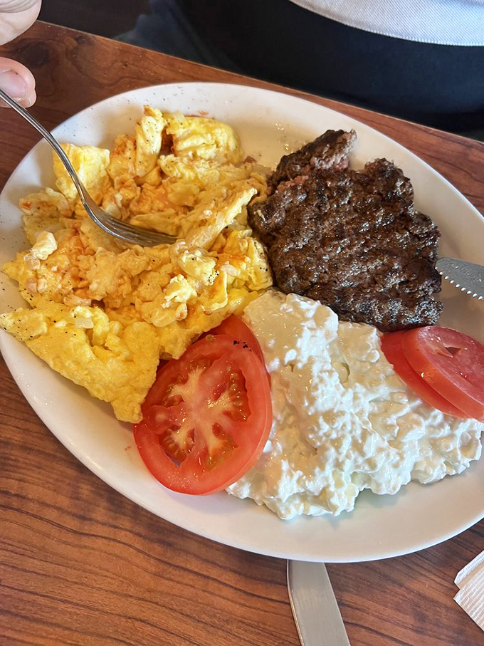 Eggs scrambled to perfection alongside a steak that didn't get the memo about breakfast foods being dainty – this is morning fuel for champions.