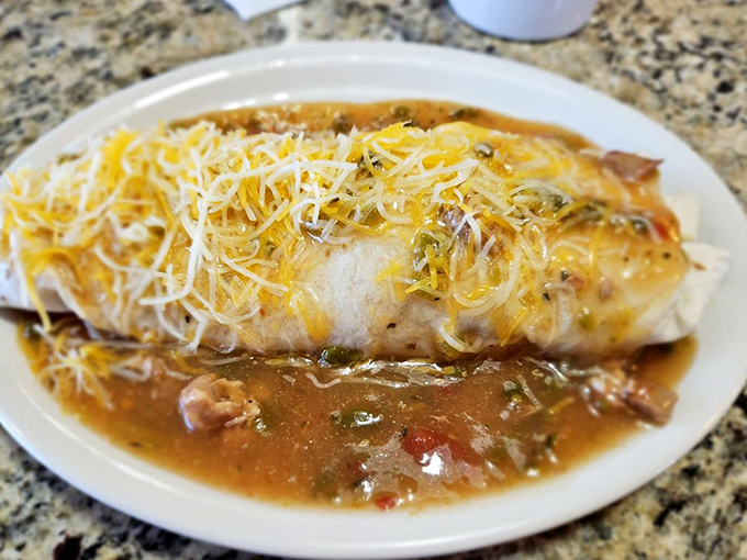 The legendary breakfast burrito in its natural habitat—swimming in chile, blanketed with cheese, waiting to cure whatever ails you.