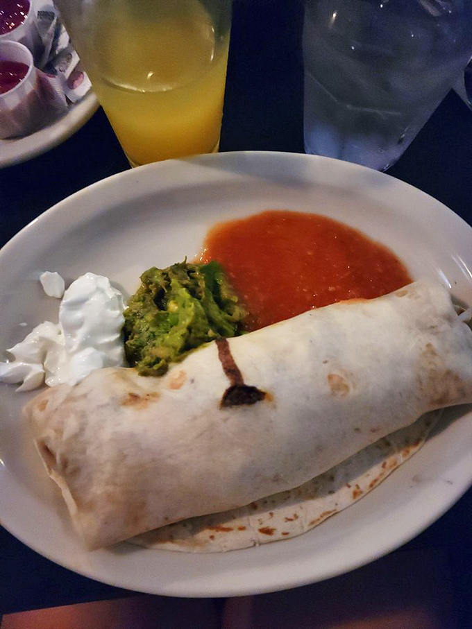 Breakfast burritos: the only acceptable way to wrap your troubles in a tortilla. This one comes with a side of salsa that could wake the dead.