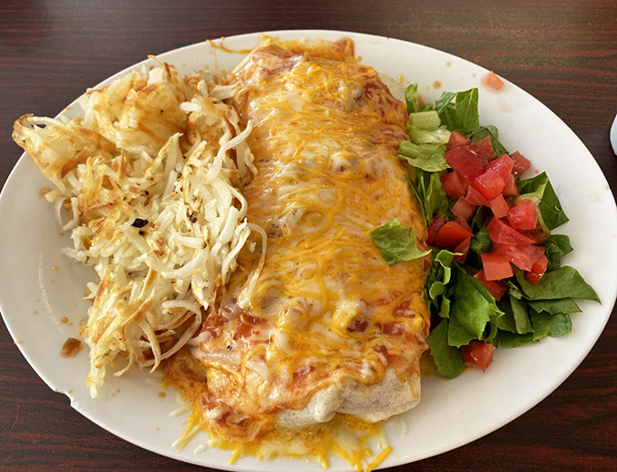 This burrito isn't just wrapped, it's embraced by melted cheese. The side of hash browns and fresh salad makes this a vacation on a plate.