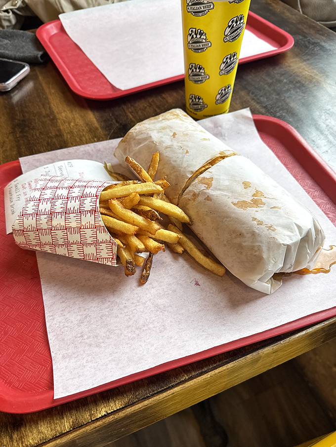 The classic Chicago dog in its natural habitat&mdash;nestled beside golden fries, wearing its yellow mustard jacket with pride.
