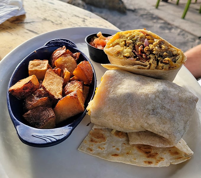 Breakfast goes coastal with this hearty burrito flanked by seasoned potatoes &ndash; the kind of morning fuel that makes you reconsider your life choices (in the best way).