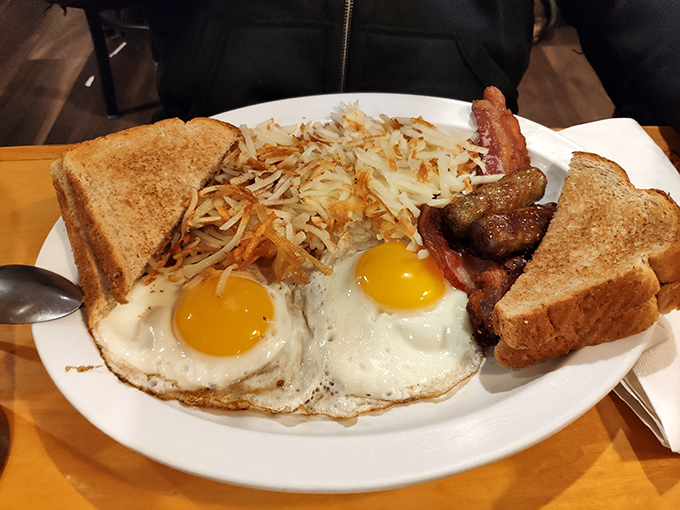 Breakfast of champions! Sunny-side-up eggs, crispy hash browns, and toast ready to soak up every last bit of yolk-y goodness.