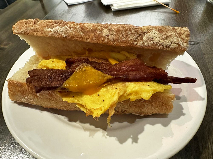 Breakfast sandwich perfection: sourdough embracing eggs and bacon like old friends reuniting. The kind of morning fuel that makes Monday feel like Saturday.