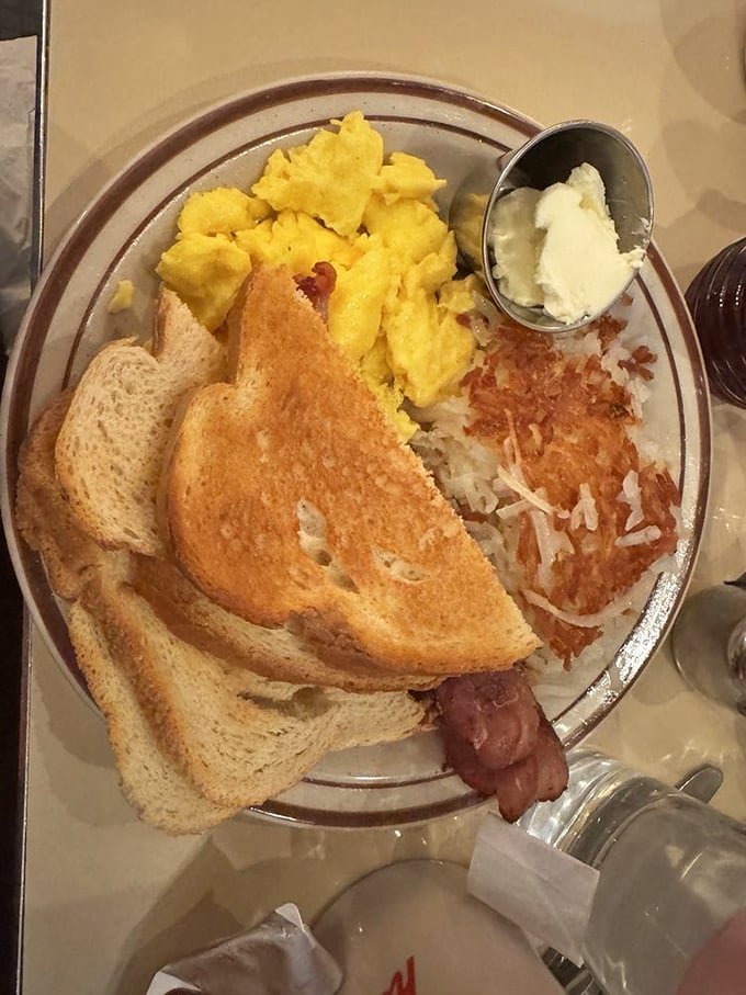 The classic American breakfast in its natural habitat—crispy hash browns, perfectly toasted bread, and eggs that would make a chicken proud.
