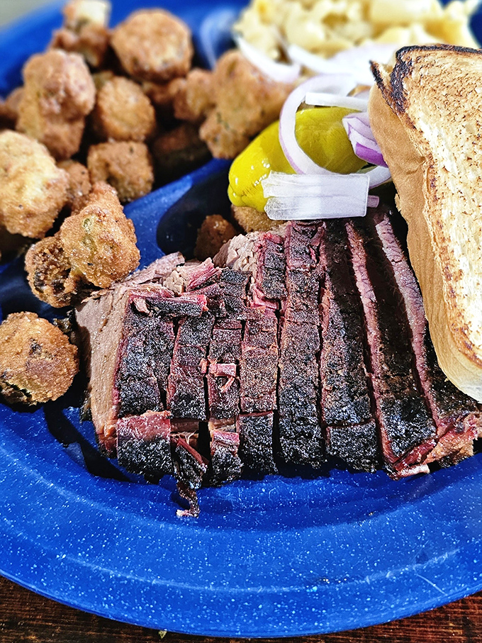 Brisket sliced thin with that telltale smoke ring, accompanied by crispy okra nuggets that could make a vegetarian question their life choices.
