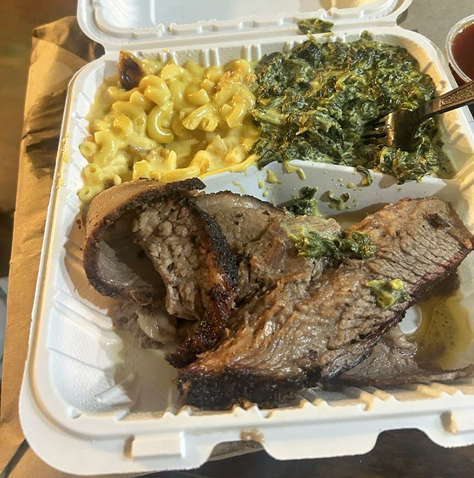 BBQ trinity on display: brisket with that perfect smoke ring, creamy mac and cheese, and collard greens. This is what dreams are made of, folks.