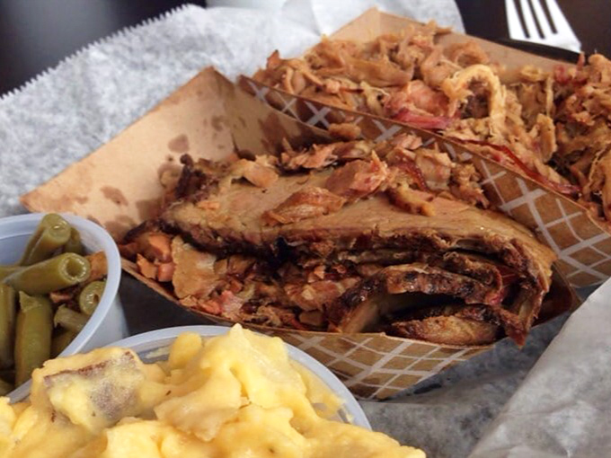 Brisket and pulled pork sharing the spotlight with mac and cheese and green beans. A harmony of textures and flavors that sings the ballad of true BBQ.