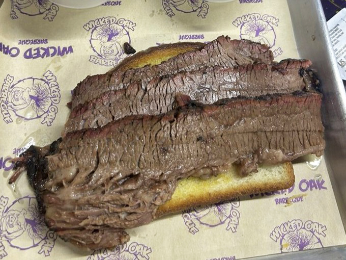 Brisket so tender it practically surrenders to your fork, sporting that coveted pink smoke ring that barbecue aficionados dream about.