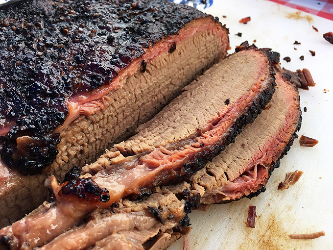 Behold the holy grail of barbecue: perfectly smoked brisket with that coveted pink smoke ring and a pepper-crusted exterior that whispers sweet nothings to your taste buds.
