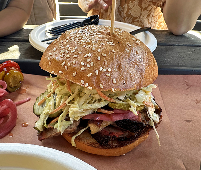 A barbecue masterpiece disguised as a sandwich – smoky brisket piled high with tangy slaw on a sesame bun. This isn't lunch; it's a religious experience.