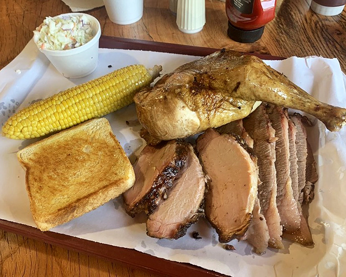 The chicken and brisket combo that's converted more vegetarians than a bacon-scented candle. That smoke ring is basically a halo of deliciousness.