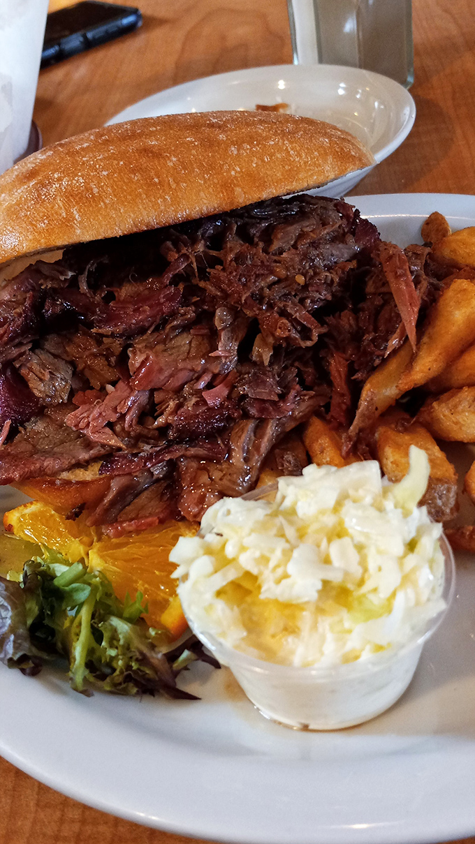 This isn't just a brisket sandwich; it's a masterclass in slow-smoking, piled high enough to make a Texan tip their hat in respect.