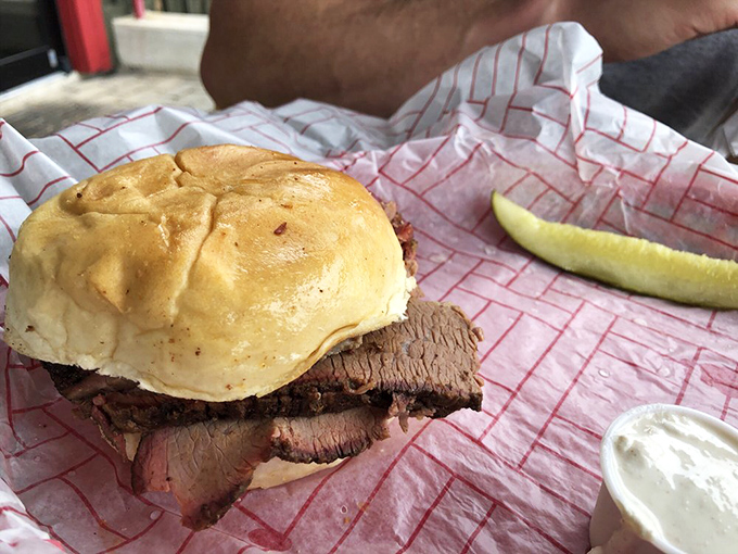 The brisket sandwich &ndash; where pillowy bun meets smoky, tender beef in a relationship so perfect it should have its own reality show.