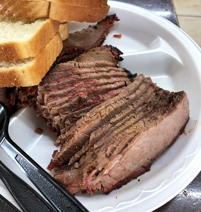 Brisket sliced so perfectly it could make a geometry teacher weep. The pink smoke ring isn't just color&mdash;it's a barbecue badge of honor.