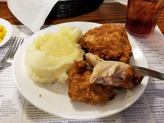 Broasted chicken so perfectly golden it belongs in a museum, paired with mashed potatoes drowning happily in gravy &ndash; a plate of Midwestern happiness.