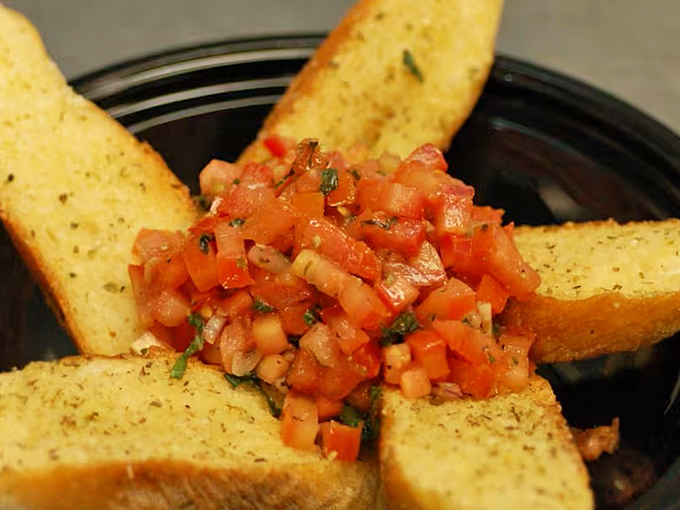 This bruschetta doesn't whisper "fresh" &ndash; it shouts it from the rooftops with diced tomatoes and herbs perched atop perfectly toasted garlic bread triangles.