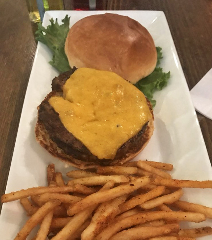 This isn't just a burger, it's frontier fuel&mdash;a hefty patty crowned with melted cheese on a fresh bun, with crispy fries standing at attention.