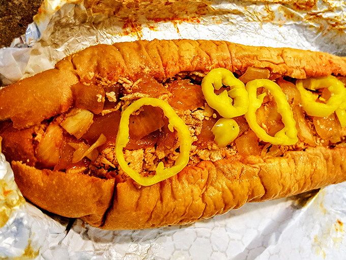 Hot peppers crown this cheesesteak like jewels on royalty. The buffalo chicken variation proves innovation and tradition can peacefully coexist.