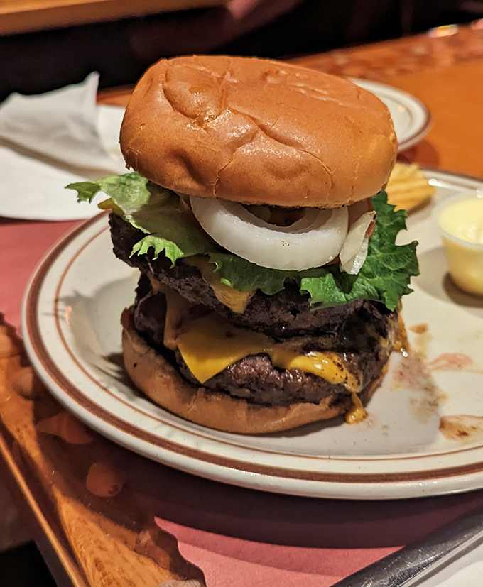 Not just a burger but a towering monument to beef architecture&mdash;where each layer contributes to a symphony of flavors that requires both hands and several napkins.