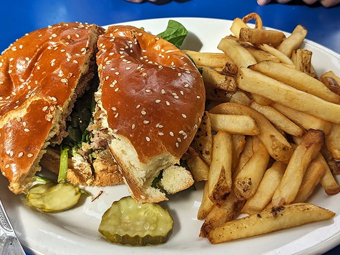 A burger that demands to be photographed before eaten, though your stomach will argue against the delay. Those fries look like they've achieved the perfect crispness.