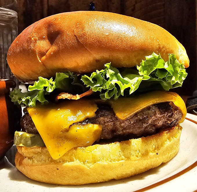 This isn't just any burger &ndash; it's a hand-formed masterpiece topped with melted cheese and fresh lettuce, demanding both hands and your undivided attention.