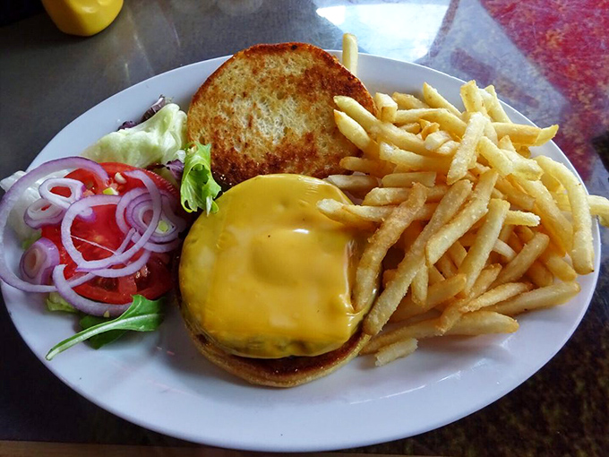 Behold the cheeseburger in paradise—golden, glistening, and guaranteed to make your diet plans walk the plank.