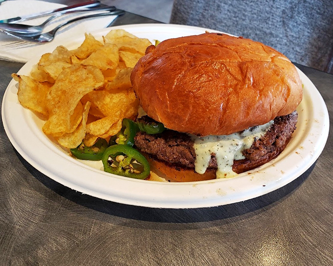 A burger that requires both hands and a strategy. That brioche bun trying valiantly to contain its contents is the unsung hero here.