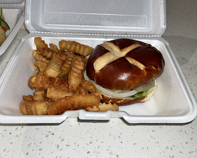 A pretzel bun burger with those signature crinkle-cut fries &ndash; proof that sometimes the best vacation souvenirs are the ones around your waistline.