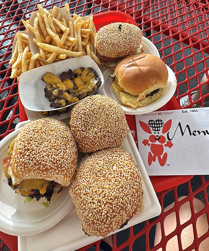 The family reunion nobody argues about—multiple Bunny Burgers gathered on a red picnic table, waiting for their moment of glory.