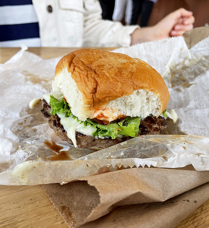 A burger that proves Tom's knows its way around more than just hot dogs, lettuce crisp and bun perfectly toasted.