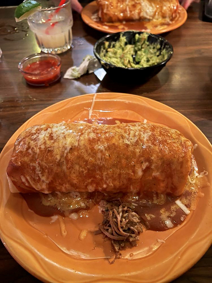 Behold the burrito in its natural habitat&mdash;smothered in sauce and cheese, waiting to fulfill its destiny as tomorrow's equally delicious leftovers.