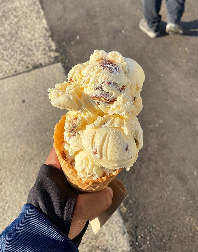 Butter pecan perfection in a waffle cone. This isn't just ice cream; it's a masterclass in texture with buttery ribbons and crunchy pecans in every bite.