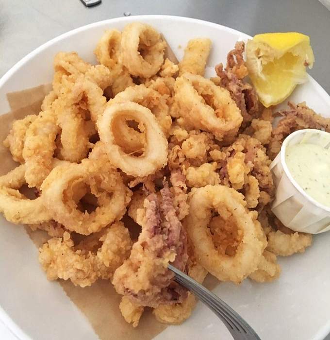 Calamari so perfectly fried it converts skeptics into believers. These golden rings and tentacles are the jewelry of the sea.