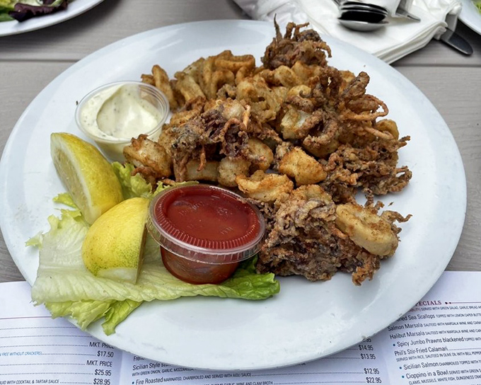 Calamari so perfectly fried it should have its own fan club. Two dipping sauces because life's too short to choose just one.