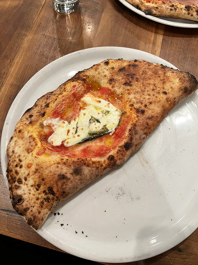 This calzone isn't just folded pizza&mdash;it's a perfectly bronzed pocket of joy that makes you wonder why you ever ordered anything else.