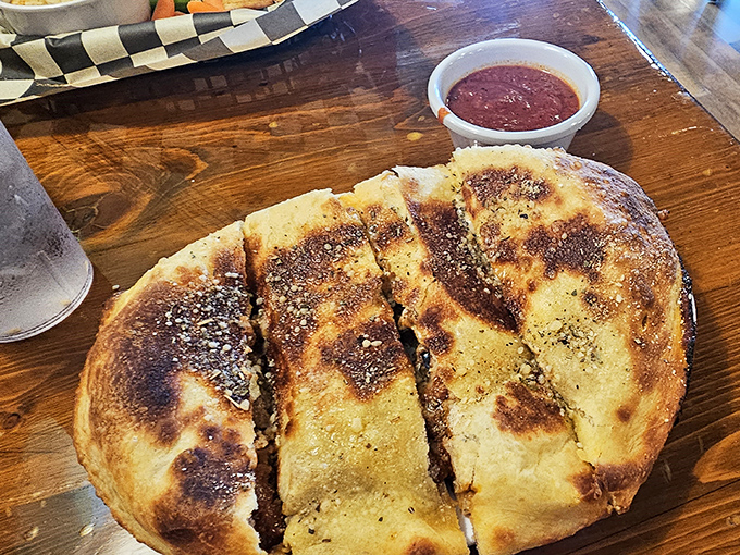 This calzone has the perfect char marks of a properly hot oven, with that golden-brown exterior hiding treasures within like some delicious pirate's chest.