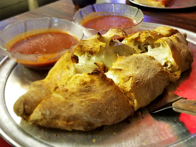 Calzones that could double as pillows for very delicious dreams. The golden-brown exterior gives way to a molten interior that demands a moment of silent appreciation.