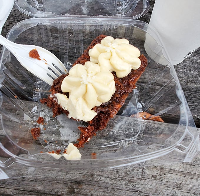 Dessert that doesn't need to shout: a simple slice of chocolate cake with cream cheese frosting that whispers, "You deserve this after that burger."