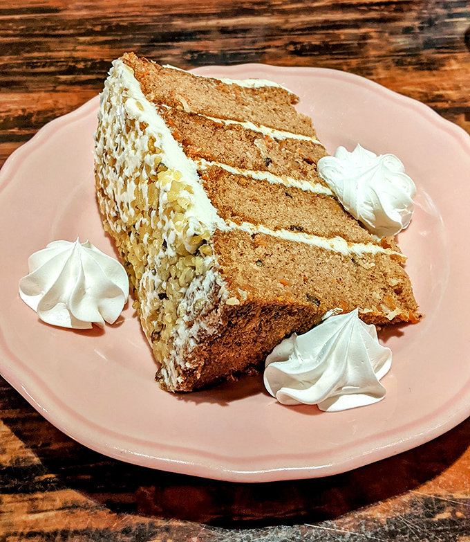 Layer upon layer of moist carrot cake with cream cheese frosting. This isn't dessert; it's an architectural achievement worthy of its own zip code.