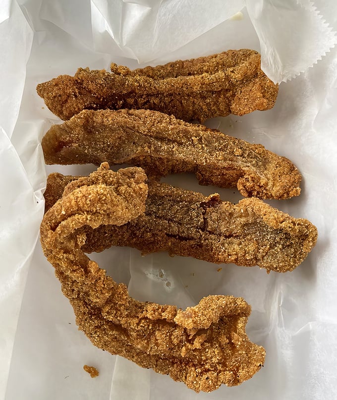 Cornmeal-crusted catfish strips that shatter with each bite&mdash;proof that Lindsey's mastery extends beyond the smoker to the fryer.