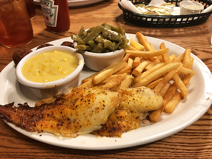 Catfish done right with that golden crust, served alongside fries, green beans, and mac and cheese that covers all comfort food bases.