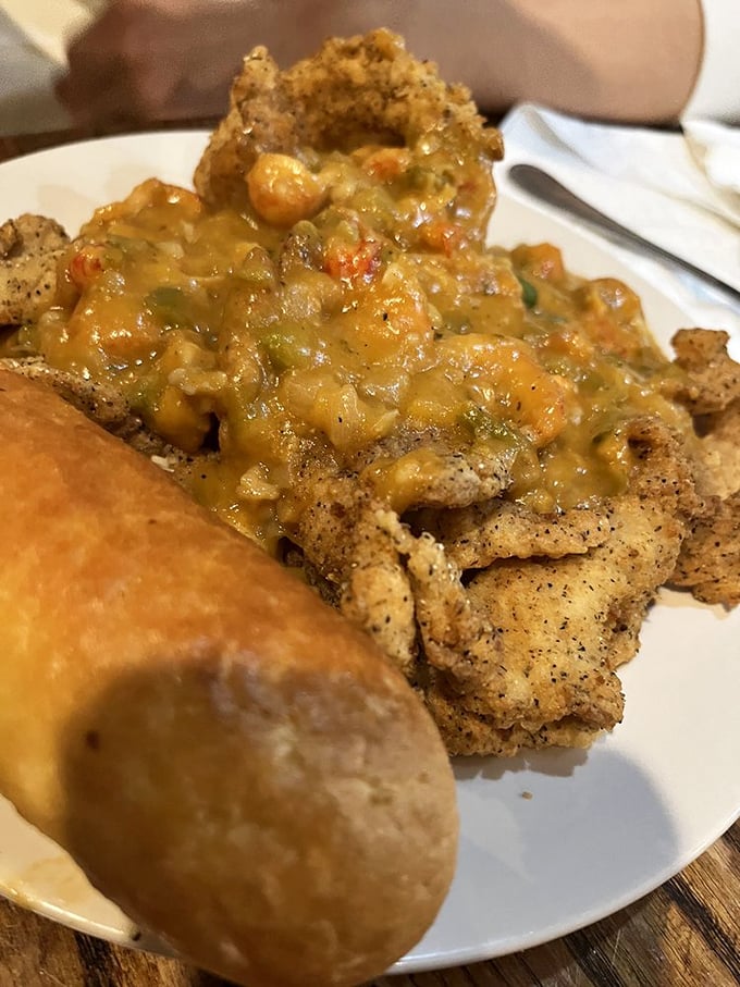 The Catfish Perdu doesn't just sit on your plate &ndash; it lounges luxuriously under a blanket of crawfish &eacute;touff&eacute;e like it's at a seafood spa.