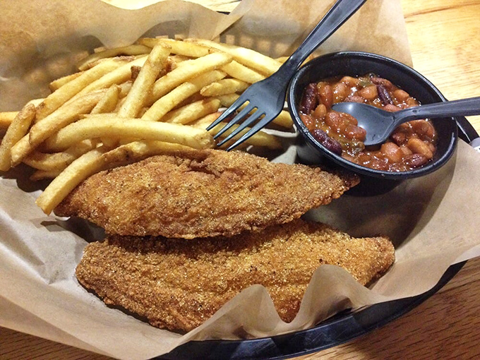 Golden cornmeal-crusted catfish fillet proves this place understands that Southern comfort food extends far beyond the smoker's embrace.